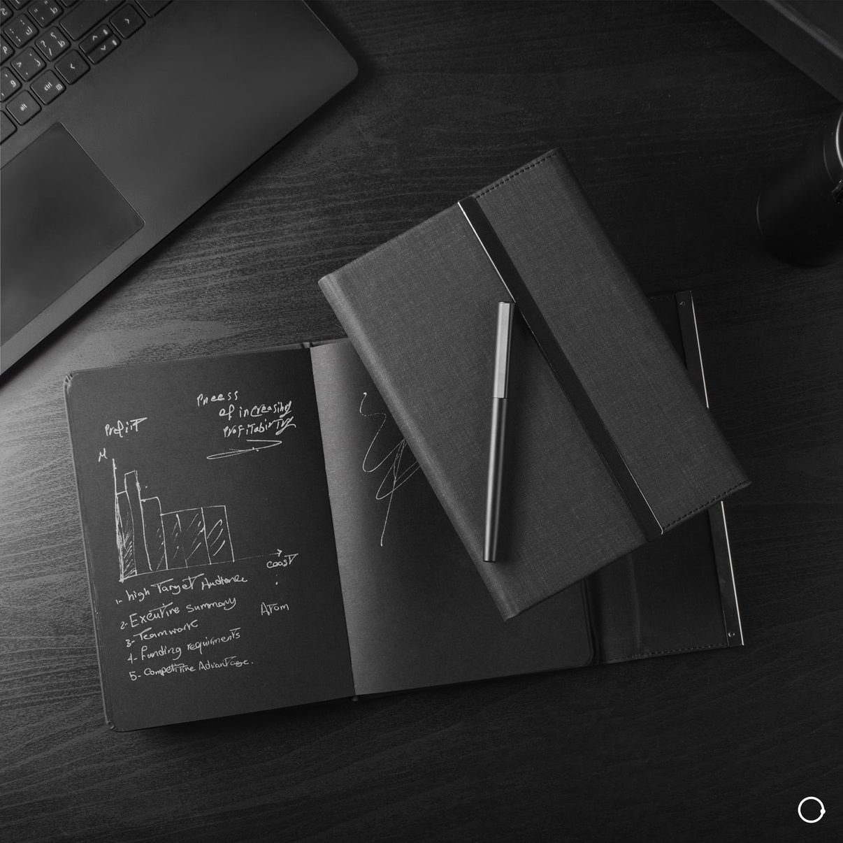 Black notebook and silver pen – Atom